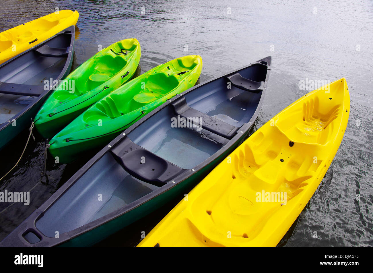 Empty canoes mooring on lake Stock Photo - Alamy