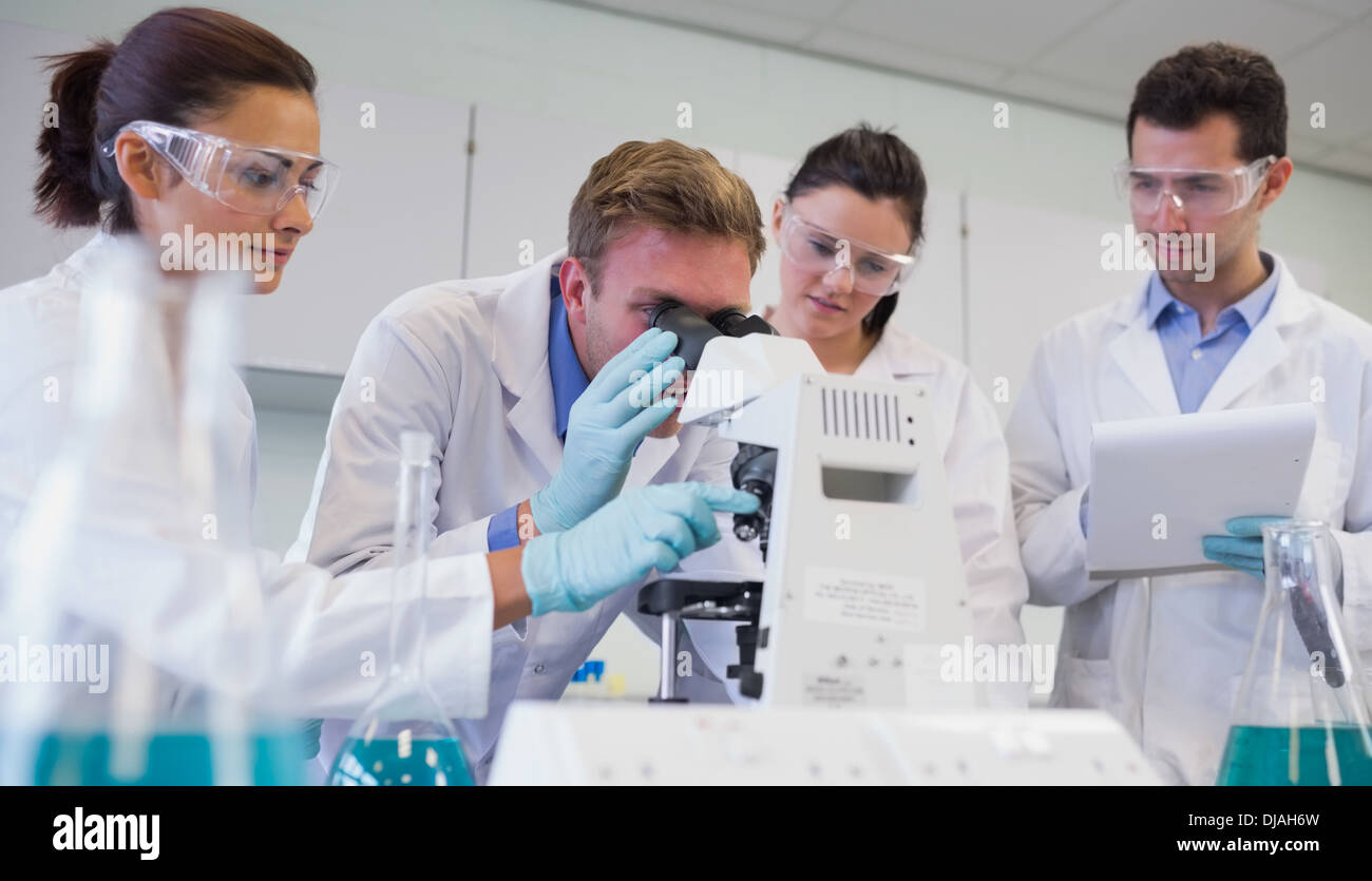 Scientists with microscope in the laboratory Stock Photo - Alamy
