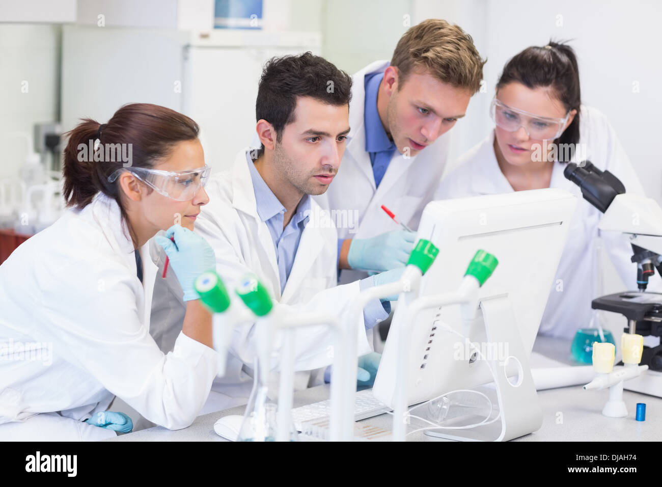 Researchers looking at computer screen in the lab Stock Photo - Alamy
