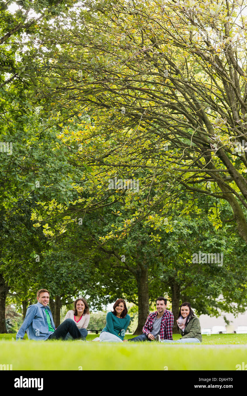 College friends sitting in lawn hi-res stock photography and images - Alamy