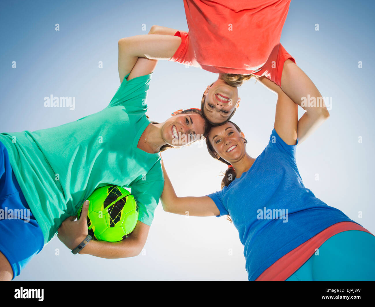 Caucasian women smiling in huddle under blue sky Stock Photo - Alamy
