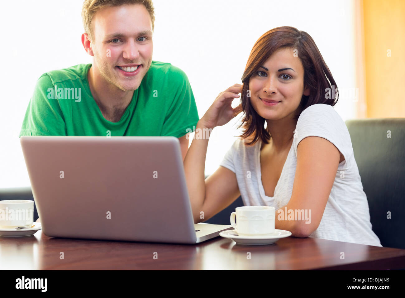 Students using laptop while having coffee at coffee shop Stock Photo ...