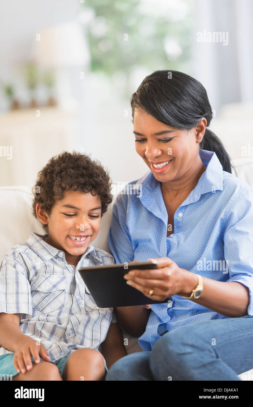 Mother and son using digital tablet Stock Photo - Alamy