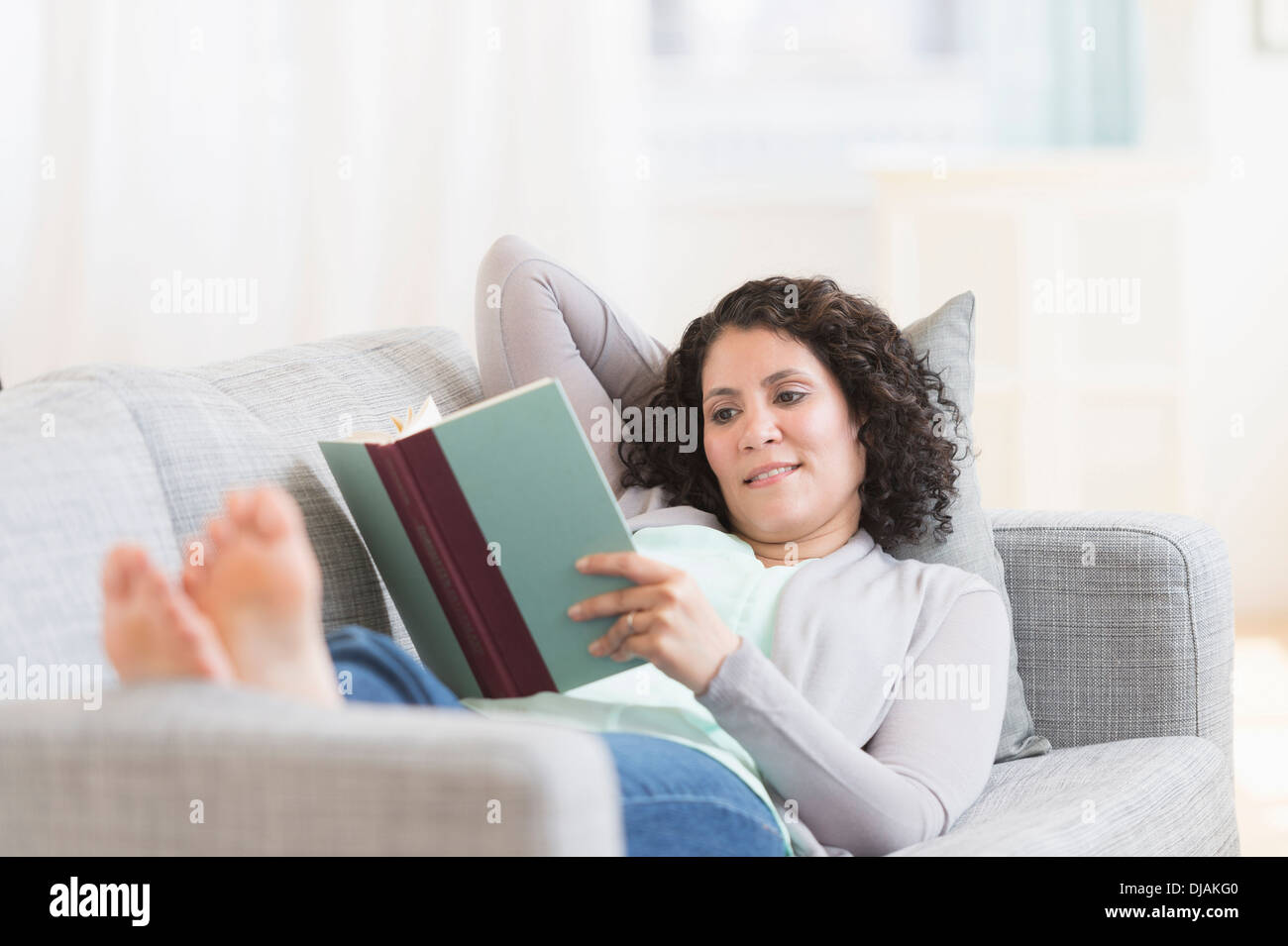 Reading book laying on sofa hi-res stock photography and images - Alamy