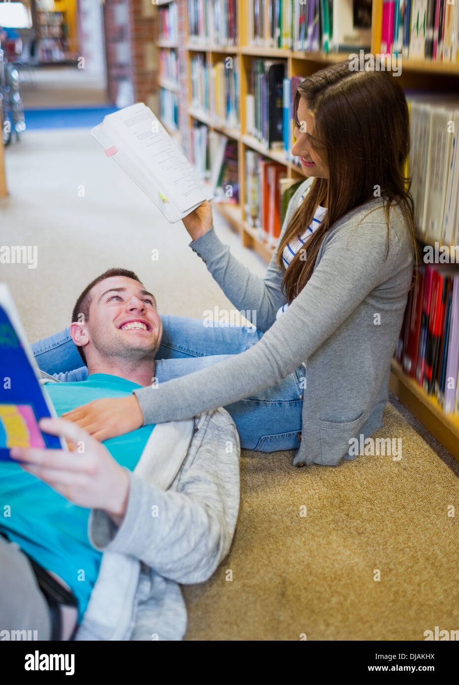 Romantic couple with books at the library aisle Stock Photo - Alamy