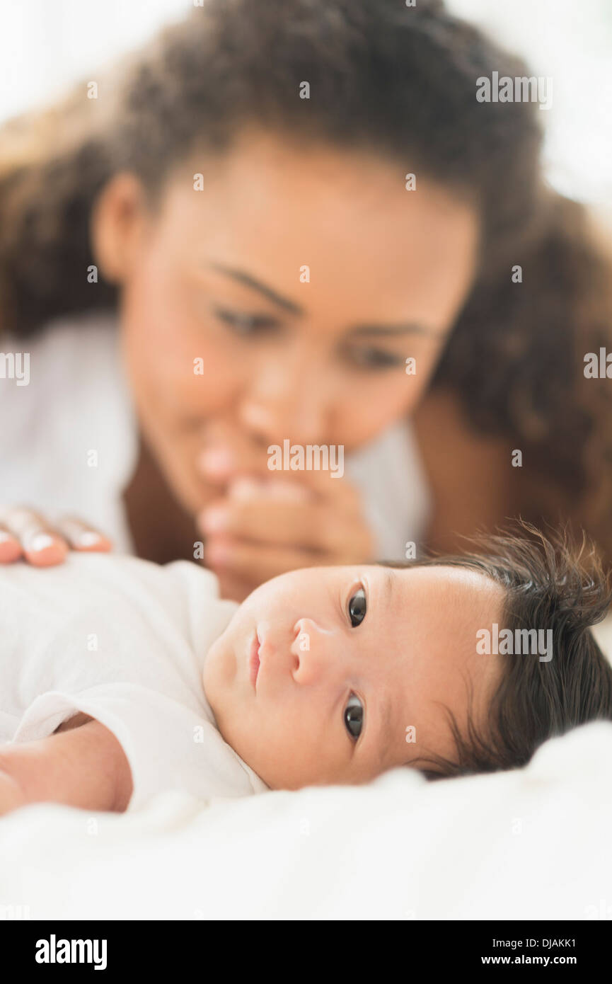 Hispanic mother admiring baby Stock Photo - Alamy