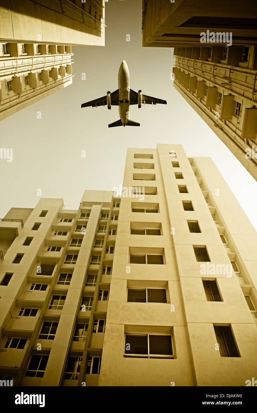 Airplane flying over a Building, Pune, Maharashtra, India Stock Photo ...