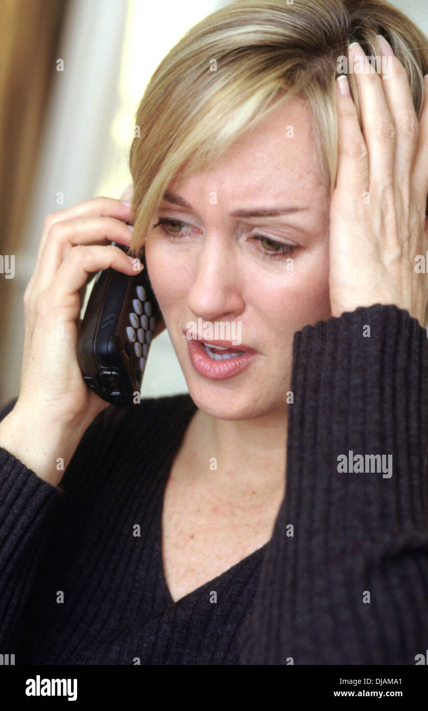 Woman on the phone looking distressed Stock Photo - Alamy