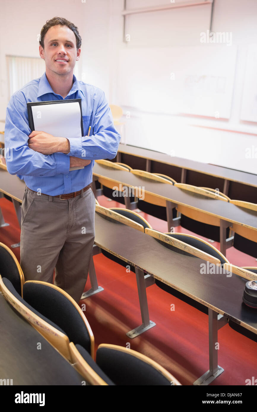 Male teacher with notepad in the lecture hall Stock Photo - Alamy