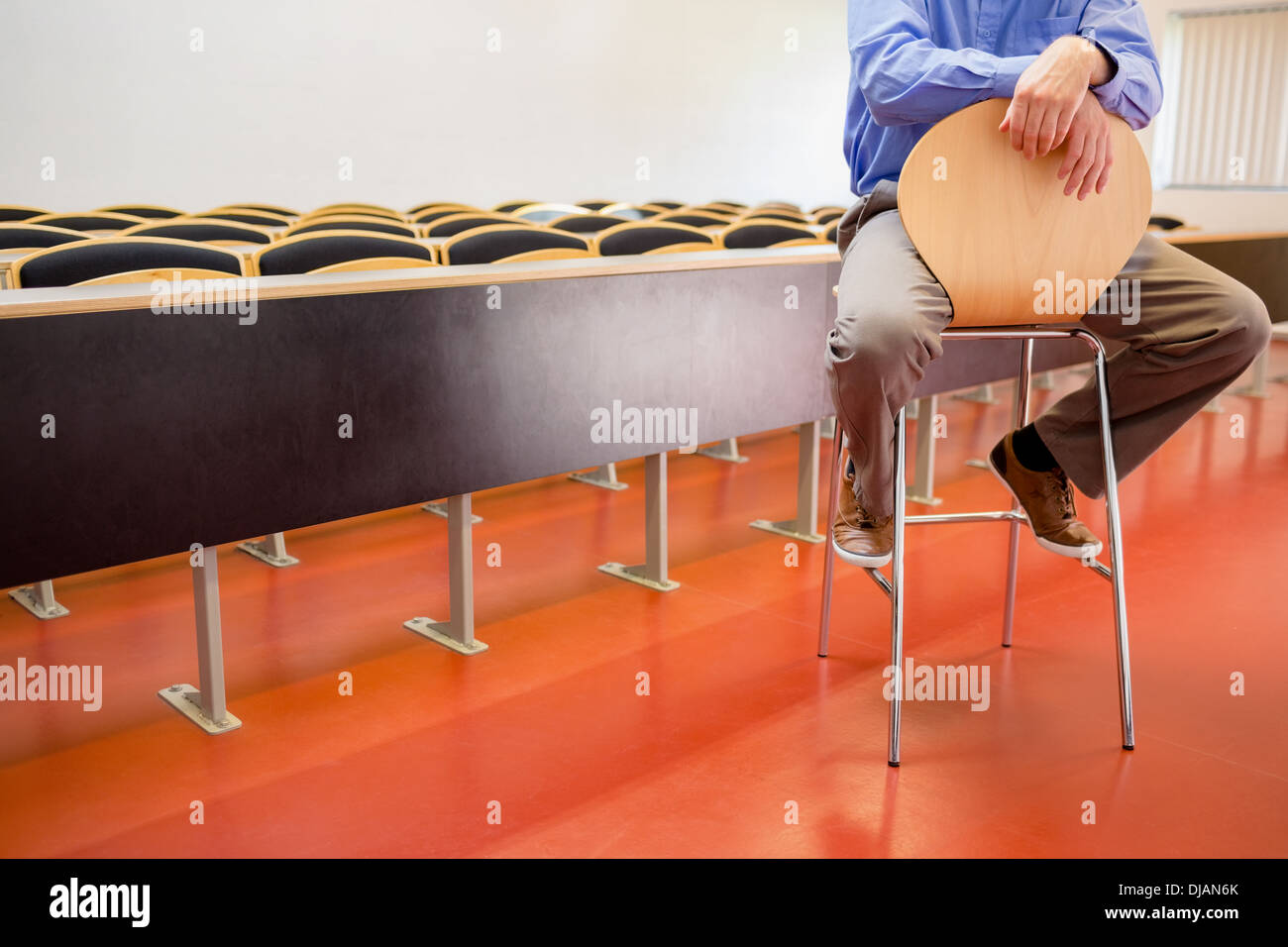 Low section of a teacher on chair in lecture hall Stock Photo - Alamy