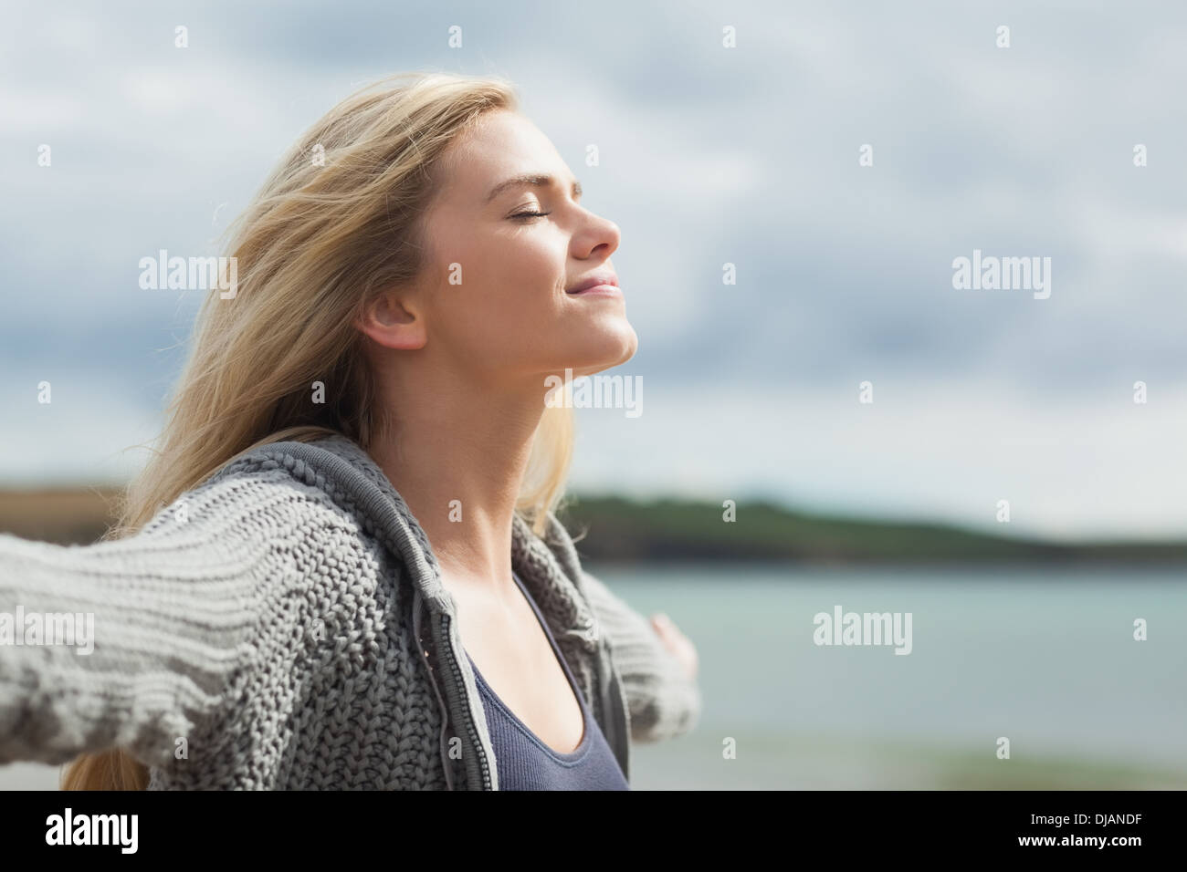Woman with arms up side view hi-res stock photography and images - Alamy