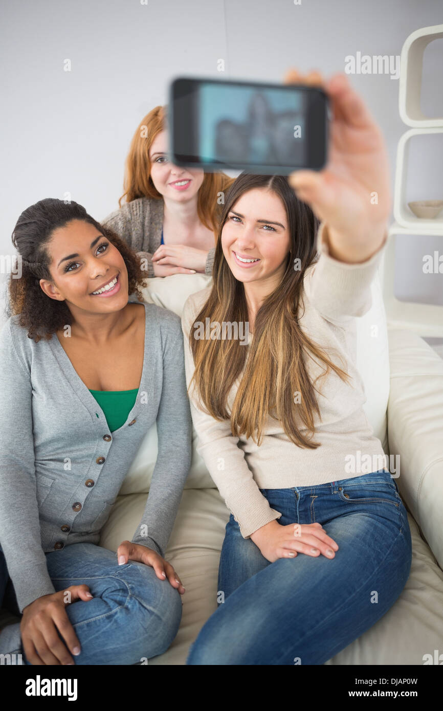 Happy friends photographing themselves with smartphone Stock Photo - Alamy