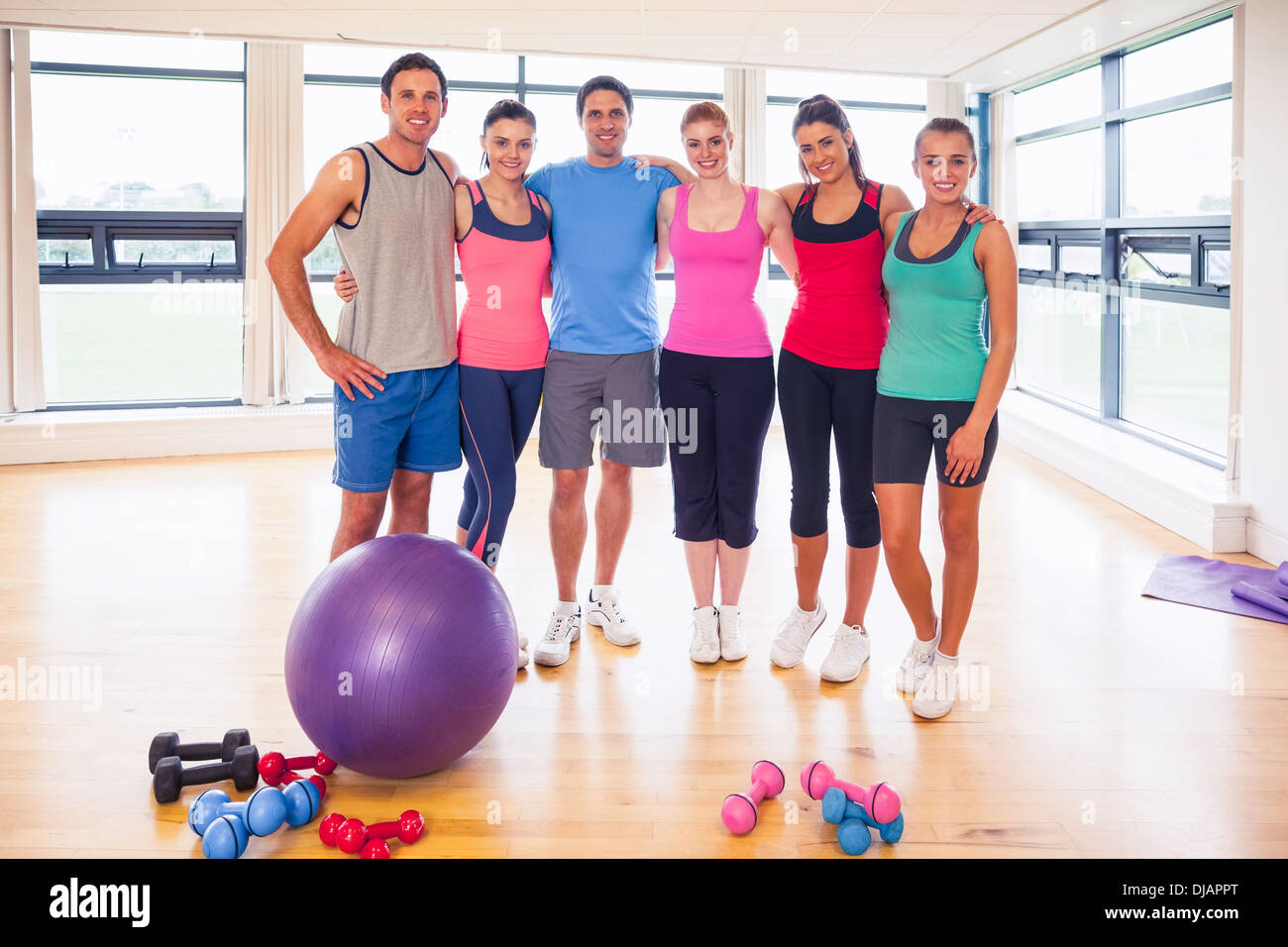 Full length portrait of fitness class at exercise room Stock Photo - Alamy