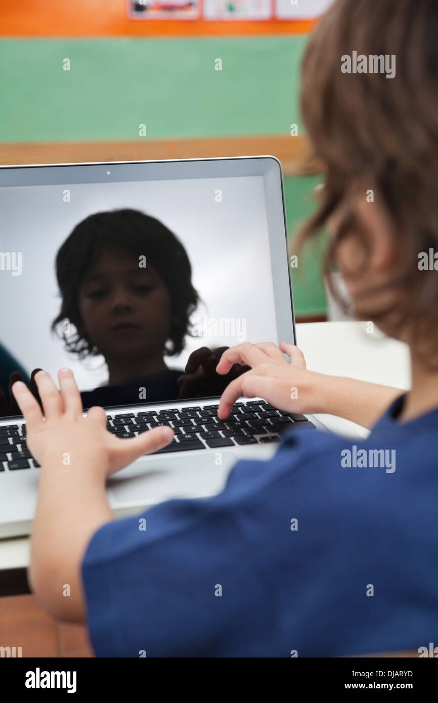 Boy Using Laptop In Classroom Stock Photo - Alamy