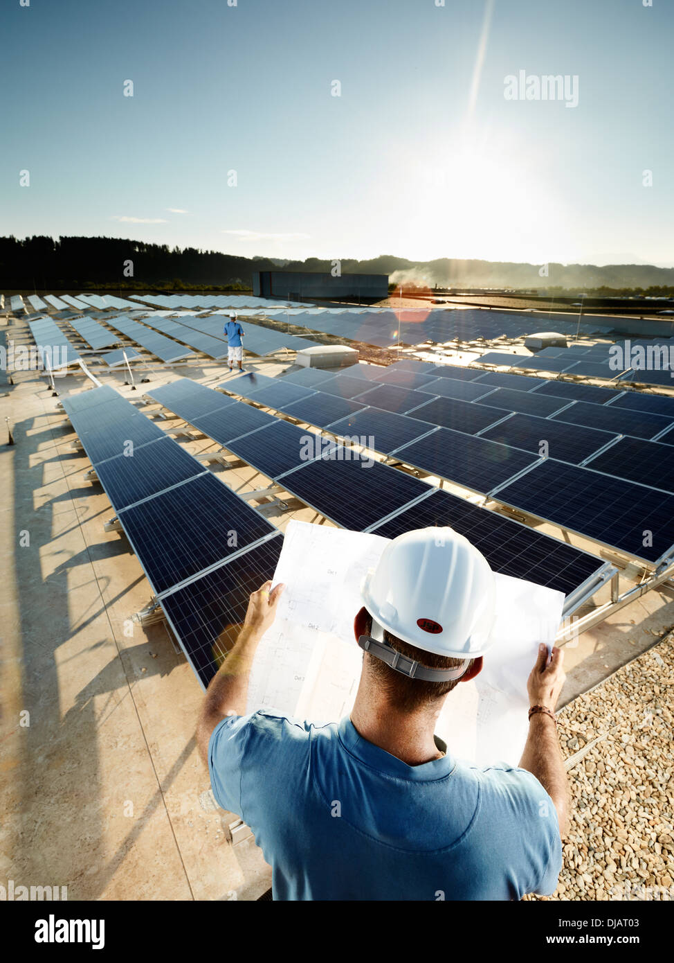 Solar installation technician studying a plan Stock Photo - Alamy