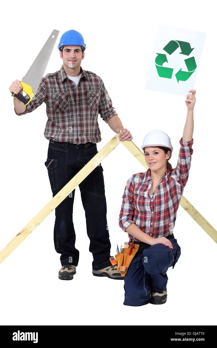 Builders with a recycle sign Stock Photo - Alamy