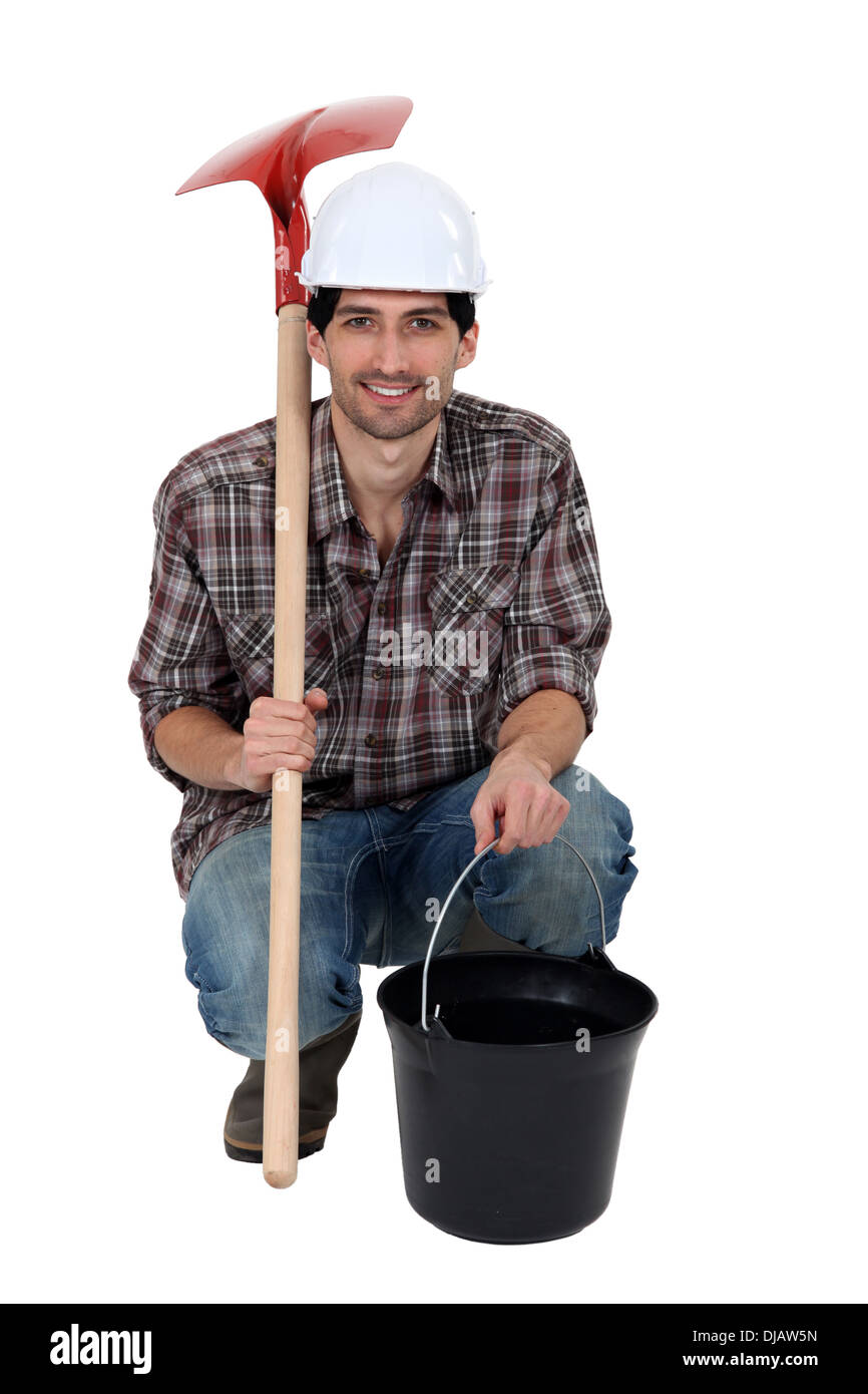 Labourer holding a spade Stock Photo - Alamy