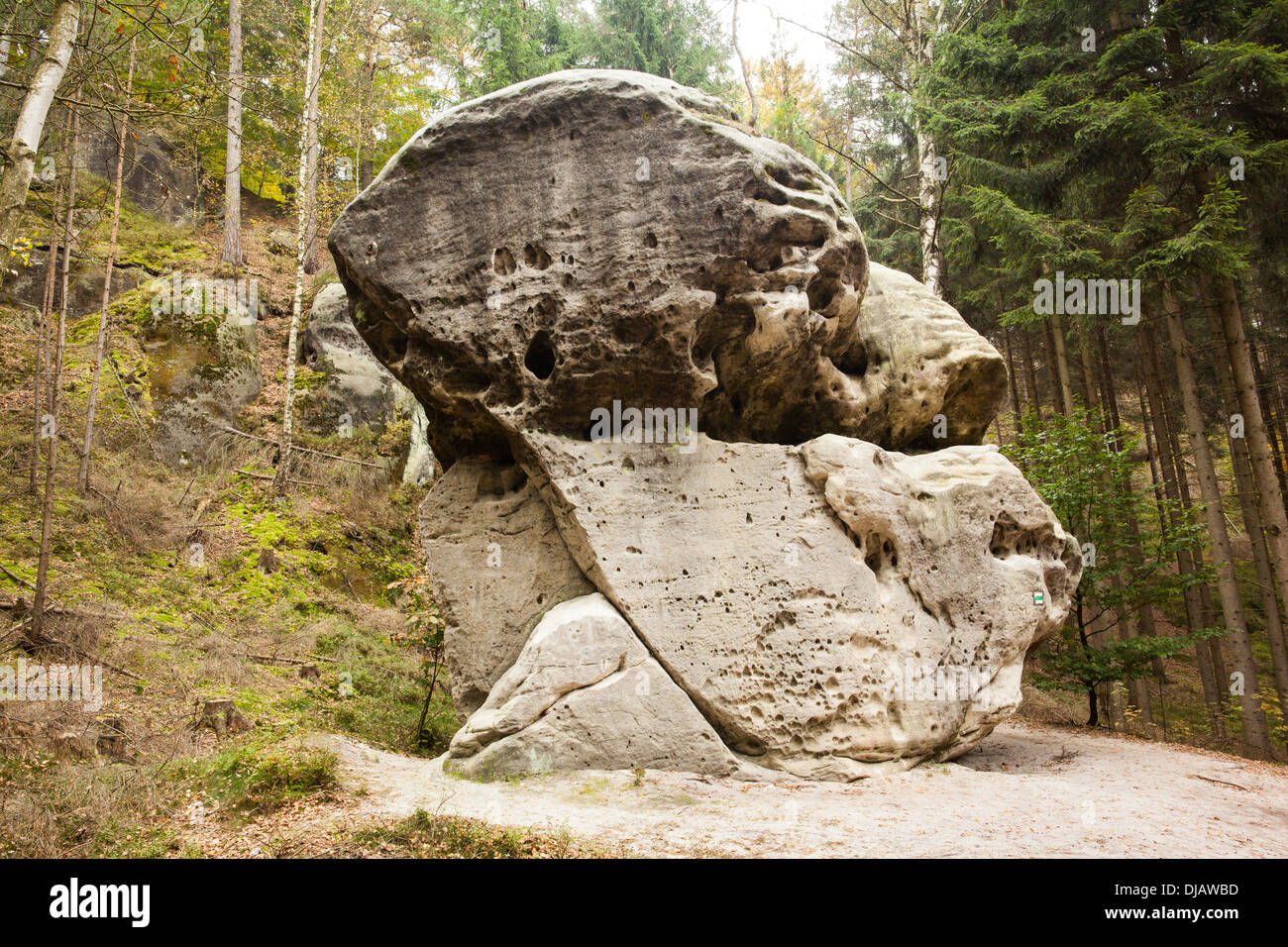 Large natural rock against trees Stock Photo - Alamy