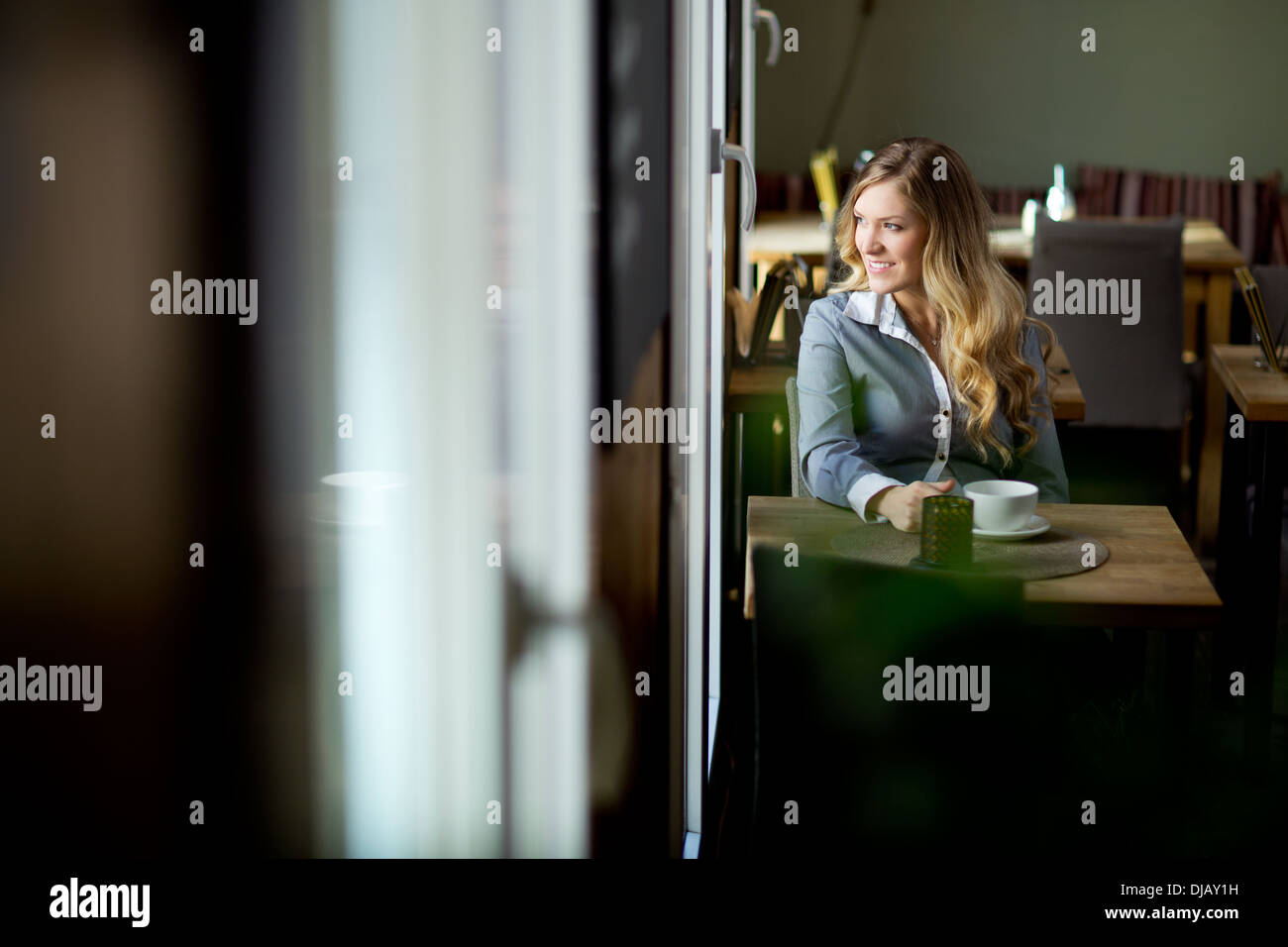 Woman alone in cafe hi-res stock photography and images - Alamy
