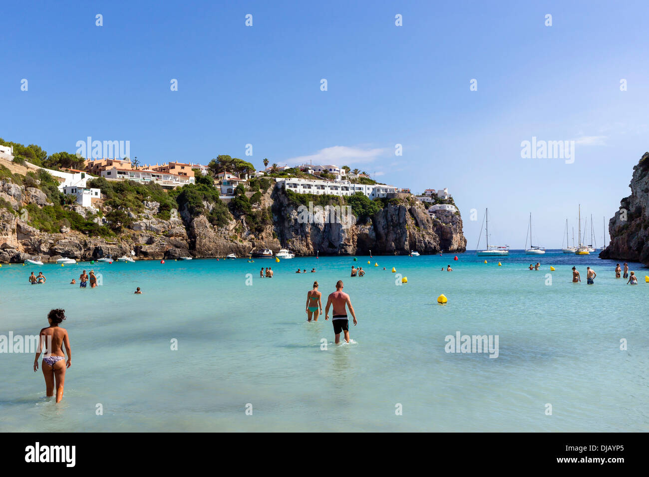 Tourists in the shallow sea, Cala en Porter, Minorca, Balearic Islands ...