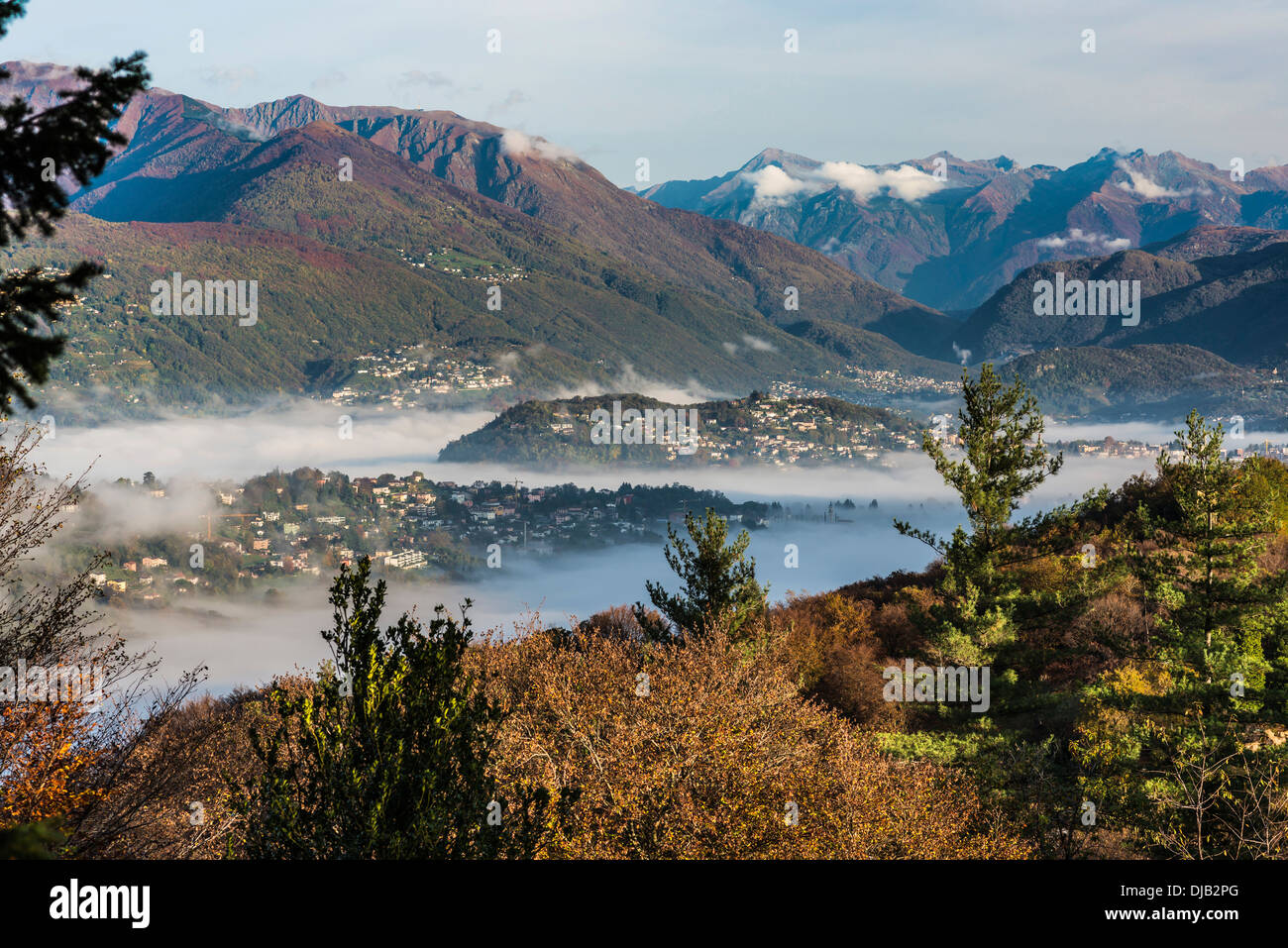 Patches of fog over Lugano on an autumn morning, seen from San Grato ...