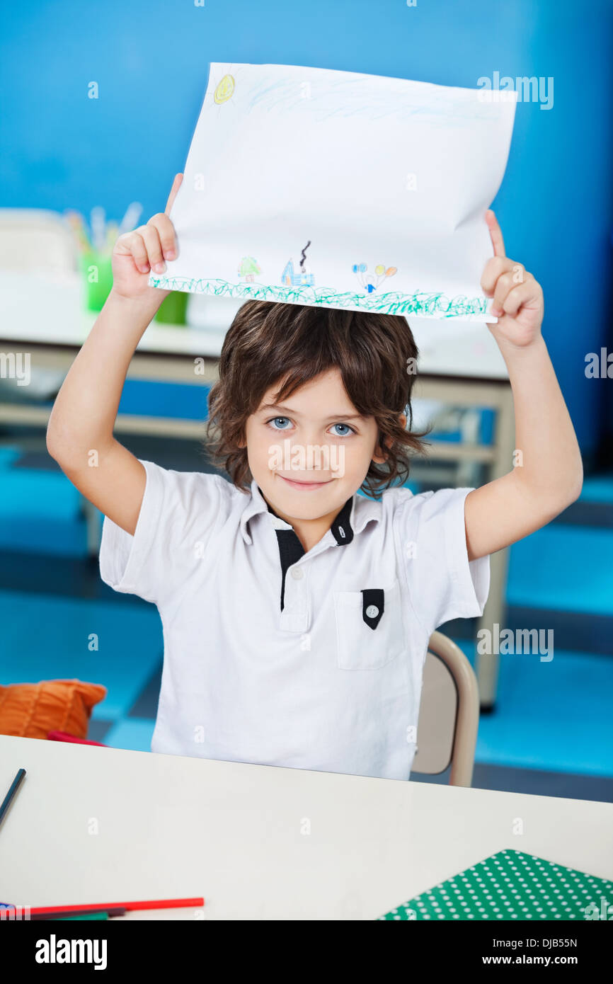 Boy Showing Drawing Paper In Classroom Stock Photo - Alamy