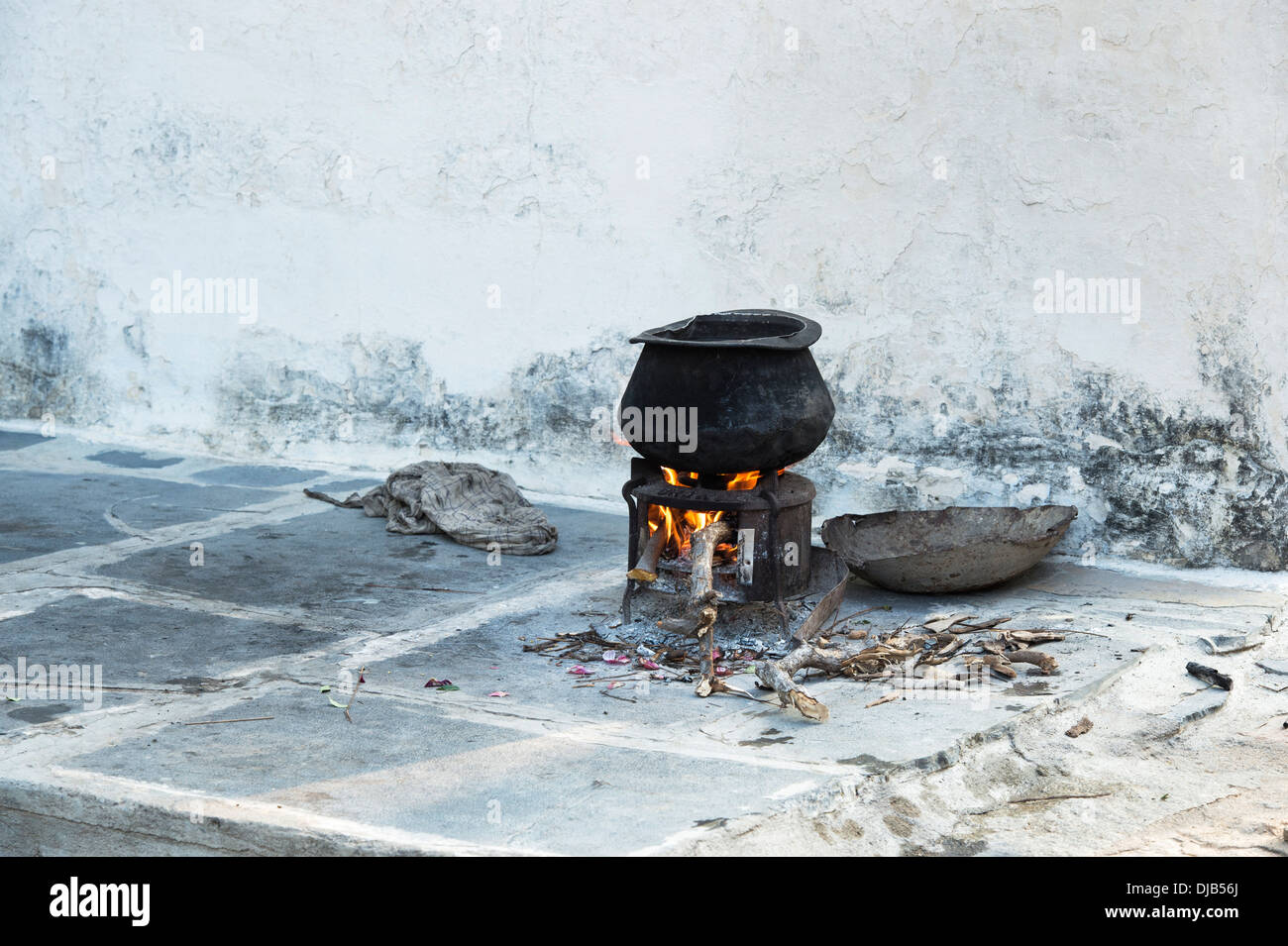 Indian cooking pot on an outside fire next to a rural indian house ...