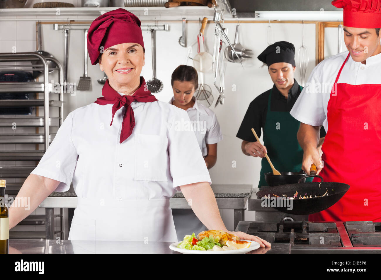 Confident Female Chef In Kitchen Stock Photo - Alamy