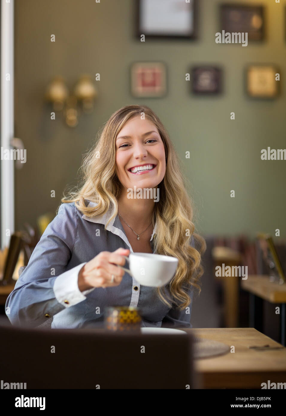 Happy Woman Drinking Coffee At Coffeeshop Stock Photo - Alamy