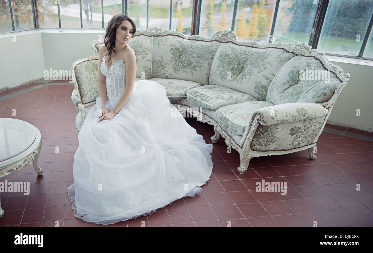 Stressed bride wearing pretty wedding gown Stock Photo - Alamy