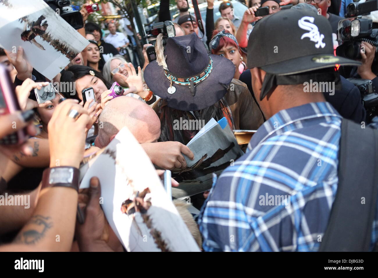 Johnny Depp surrounded by fans outside the Bowery Hotel in Manhattan ...