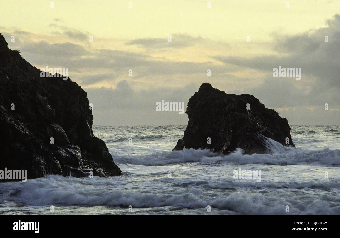 A stormy sea crashes around a sea stack at sunset in Morgan Porth Bay ...