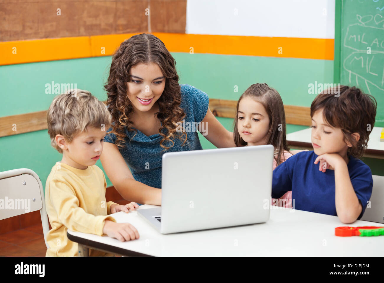 Teacher And Students Using Laptop In Class Stock Photo - Alamy