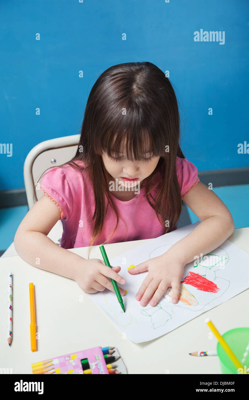 Girl Drawing With Sketch Pen In Classroom Stock Photo - Alamy