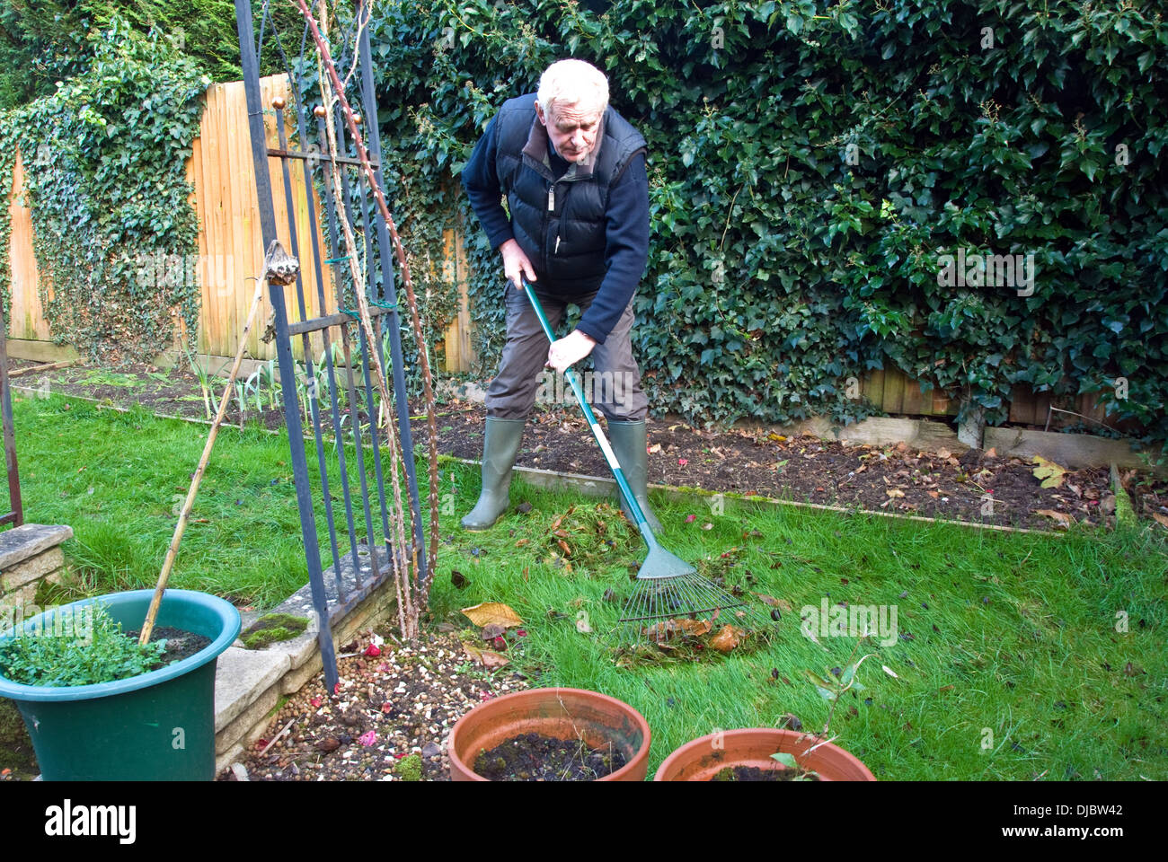 Male raking grass hi-res stock photography and images - Alamy