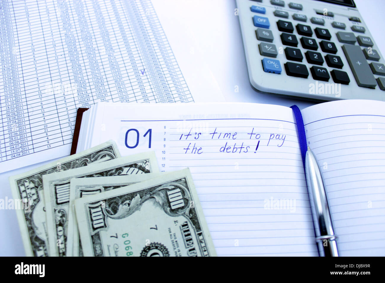 writing down in a notebook about a debt and american dollars Stock ...