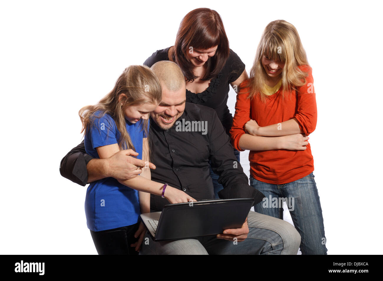 smiling happy family looking at computer on white background Stock ...