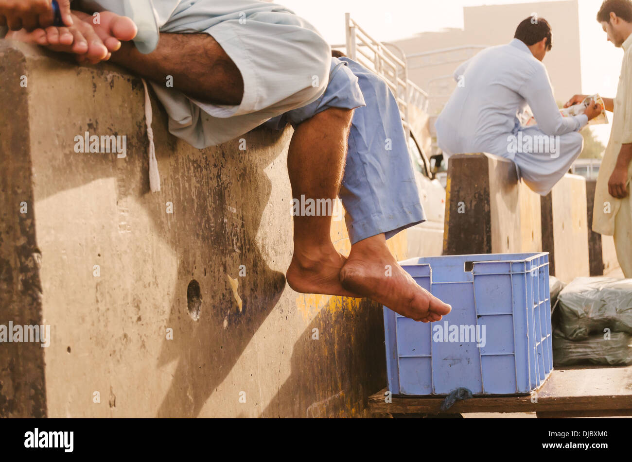 Arab men sitting outside Deira's Fish Market. Dubai, UAE Stock Photo ...