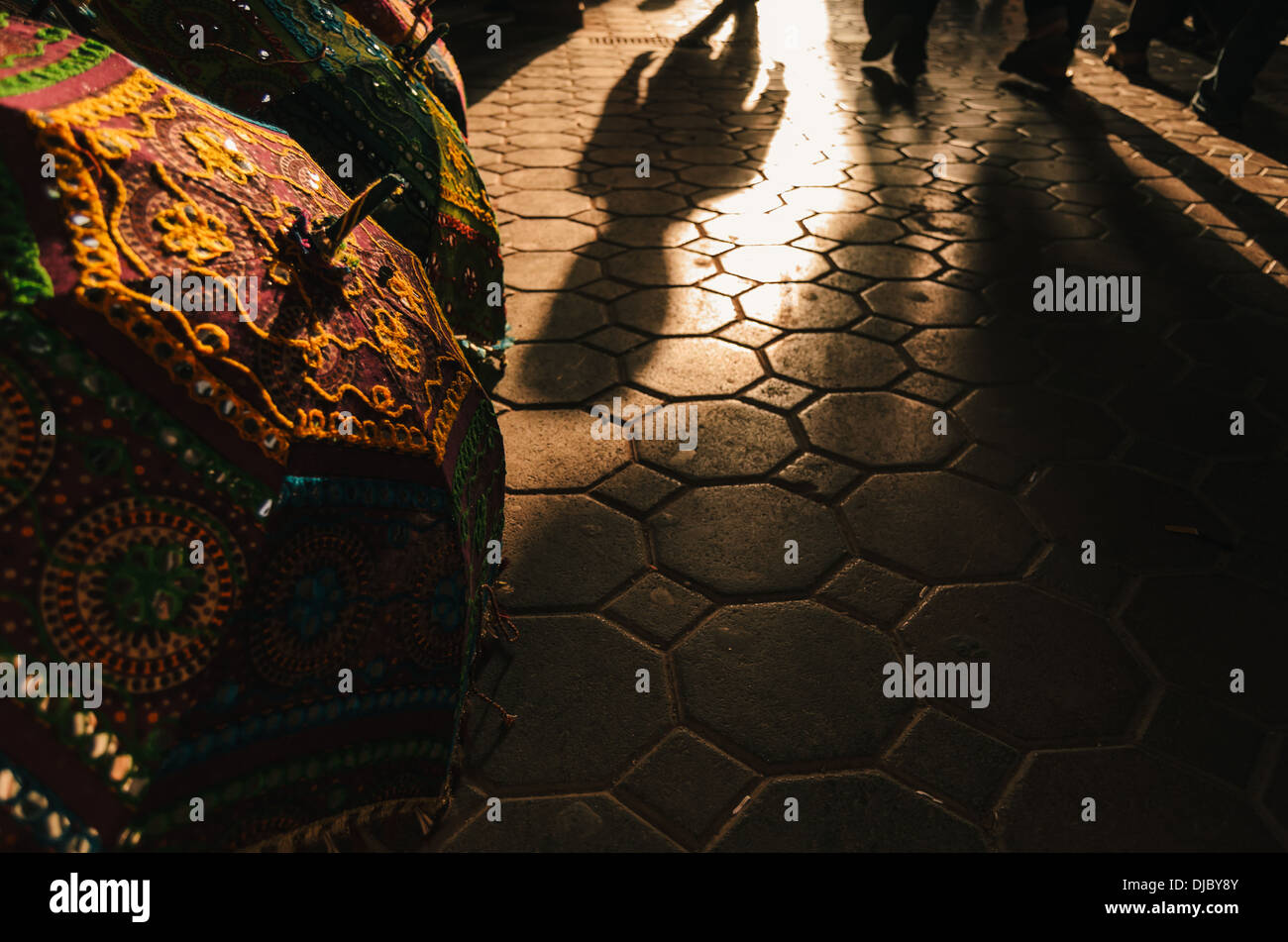 The deep shadow of a man walking at Bur Dubai Souk is projected on the ...