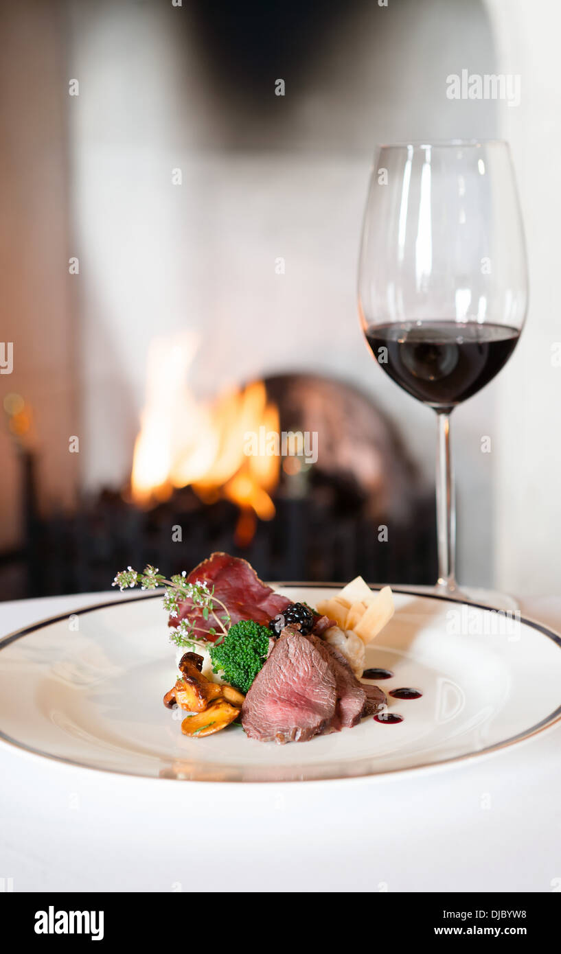 Dinner by a roaring hot fire Stock Photo - Alamy