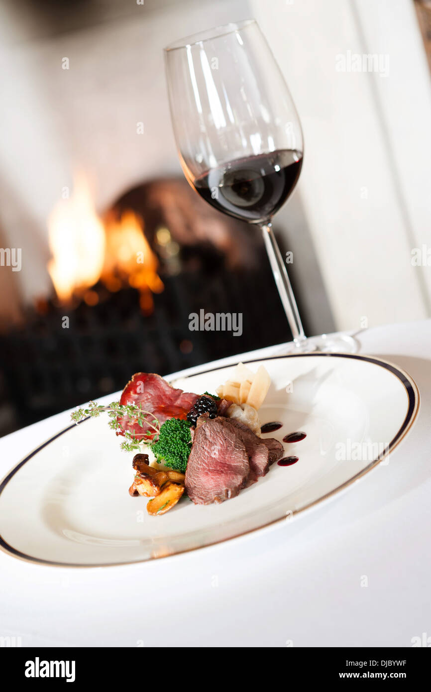 Dinner by a roaring hot fire Stock Photo - Alamy