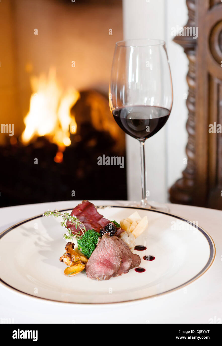 Dinner by a roaring hot fire Stock Photo - Alamy