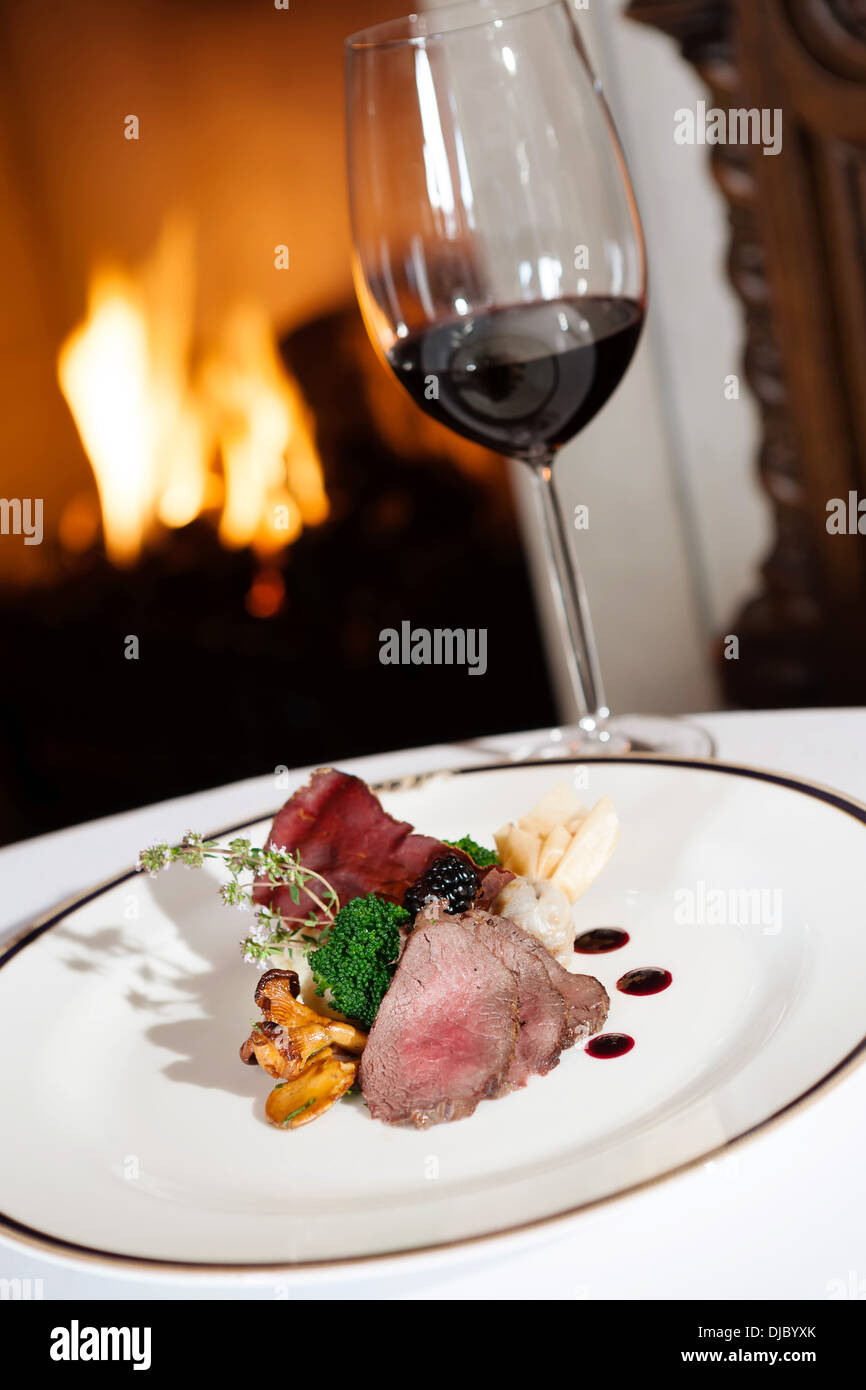 Dinner by a roaring hot fire Stock Photo - Alamy