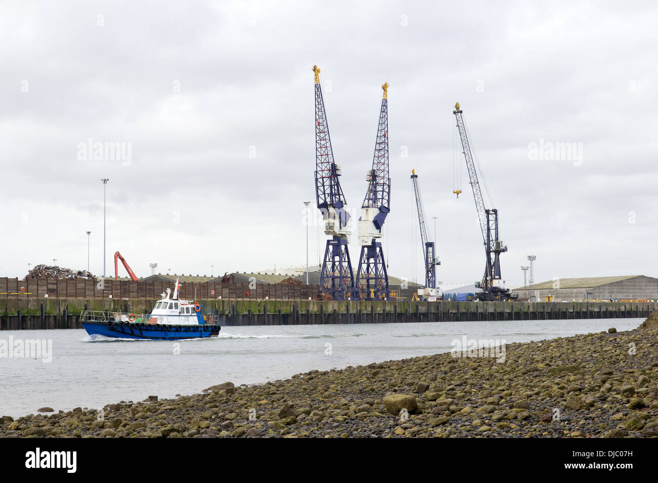 The Headland Hartlepool cranes, dock and a ship going out to sea Stock ...