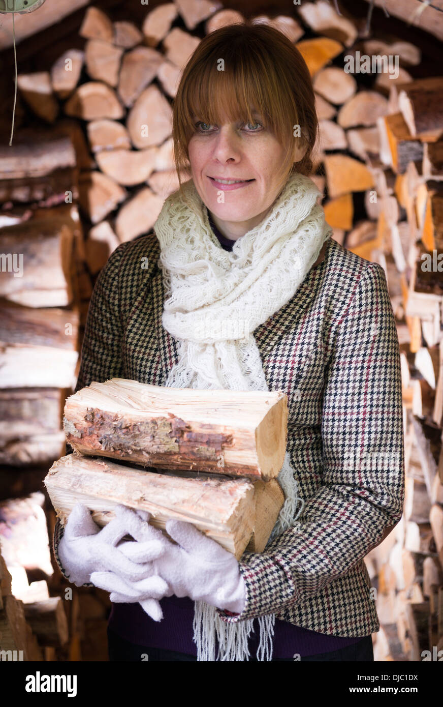 A woman collecting logs for a fire Stock Photo - Alamy