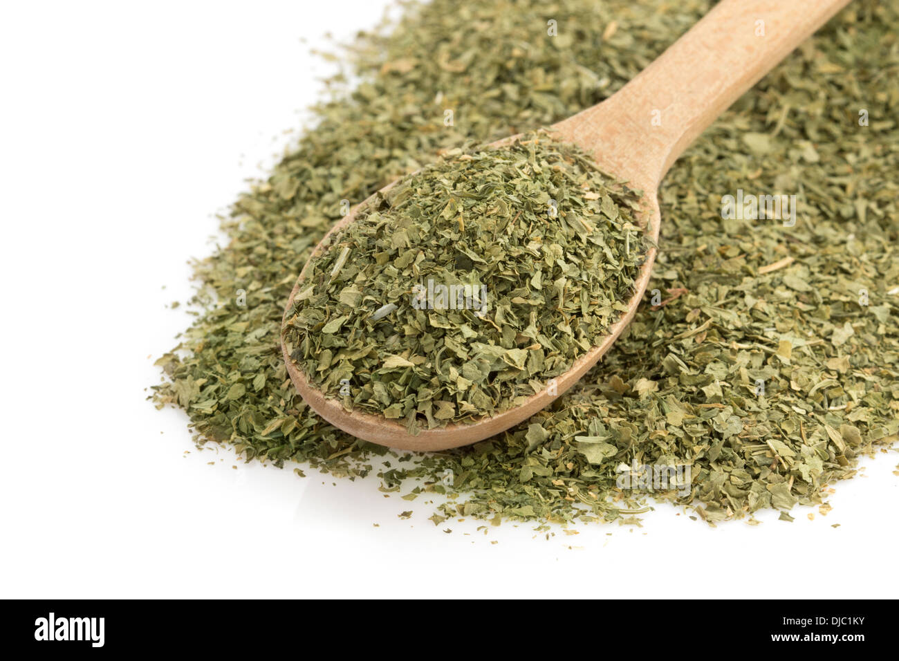 dried green spices in spoon isolated on white background Stock Photo ...