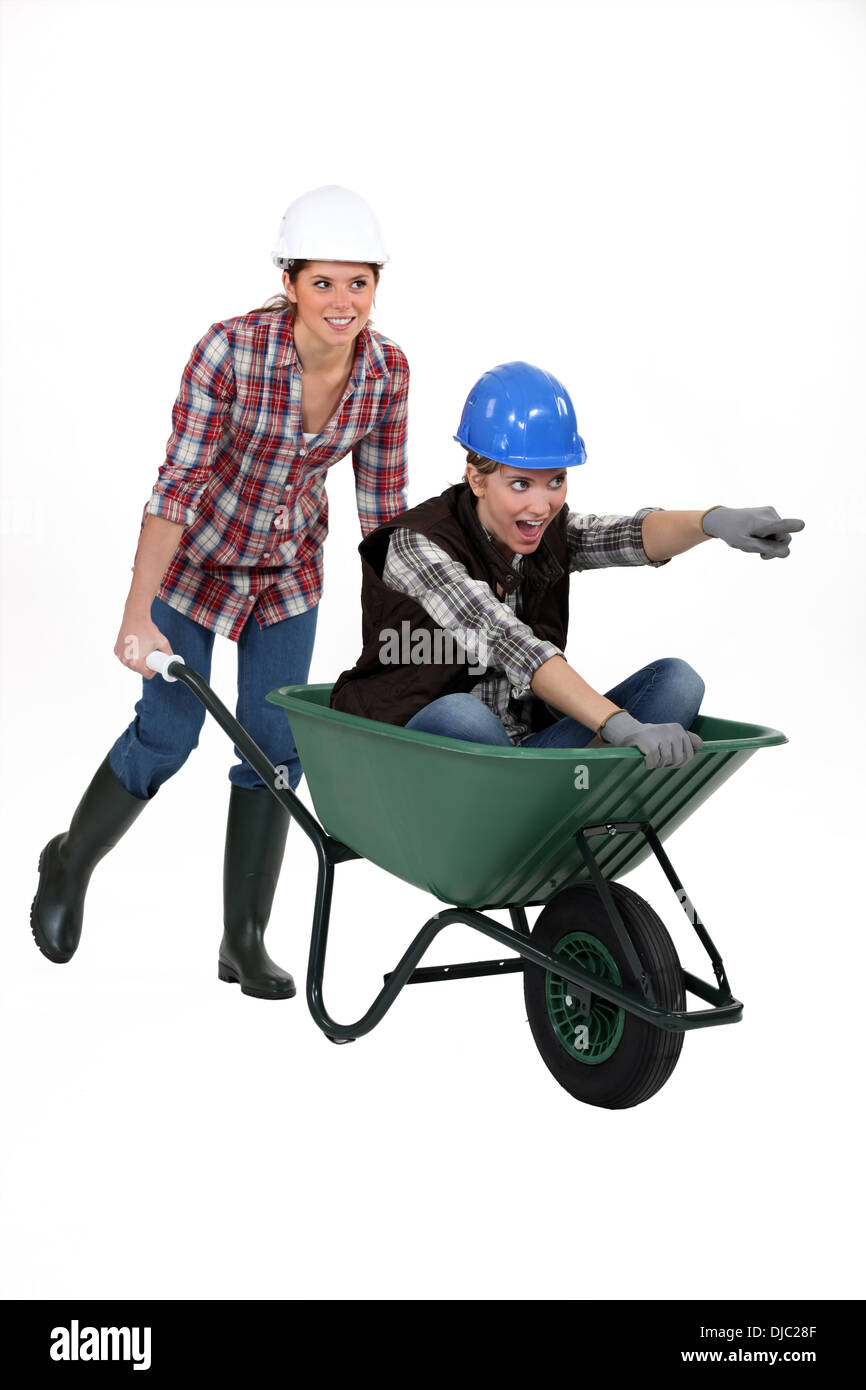 Woman being pushed in wheelbarrow Stock Photo - Alamy