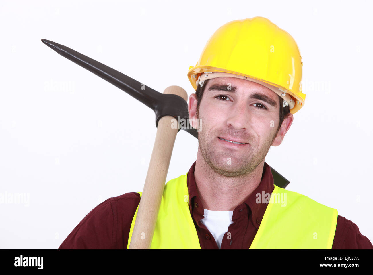 Construction worker holding pick-Axe Stock Photo - Alamy