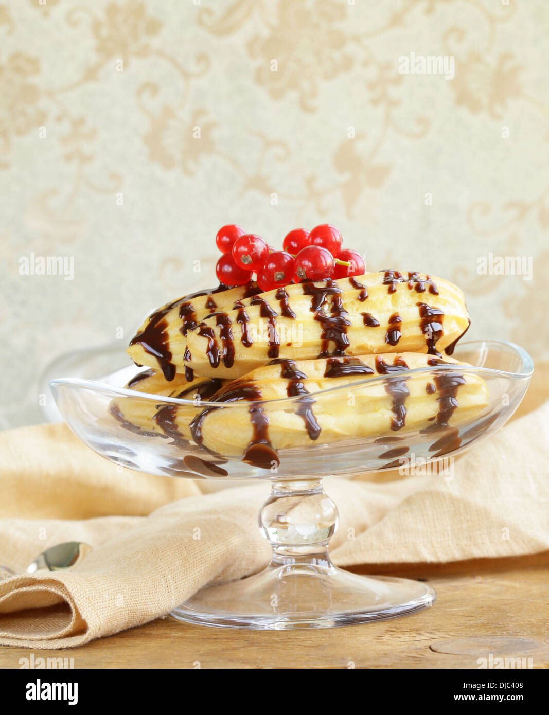 choux pastry eclairs on glass stand base, festive dessert Stock Photo ...