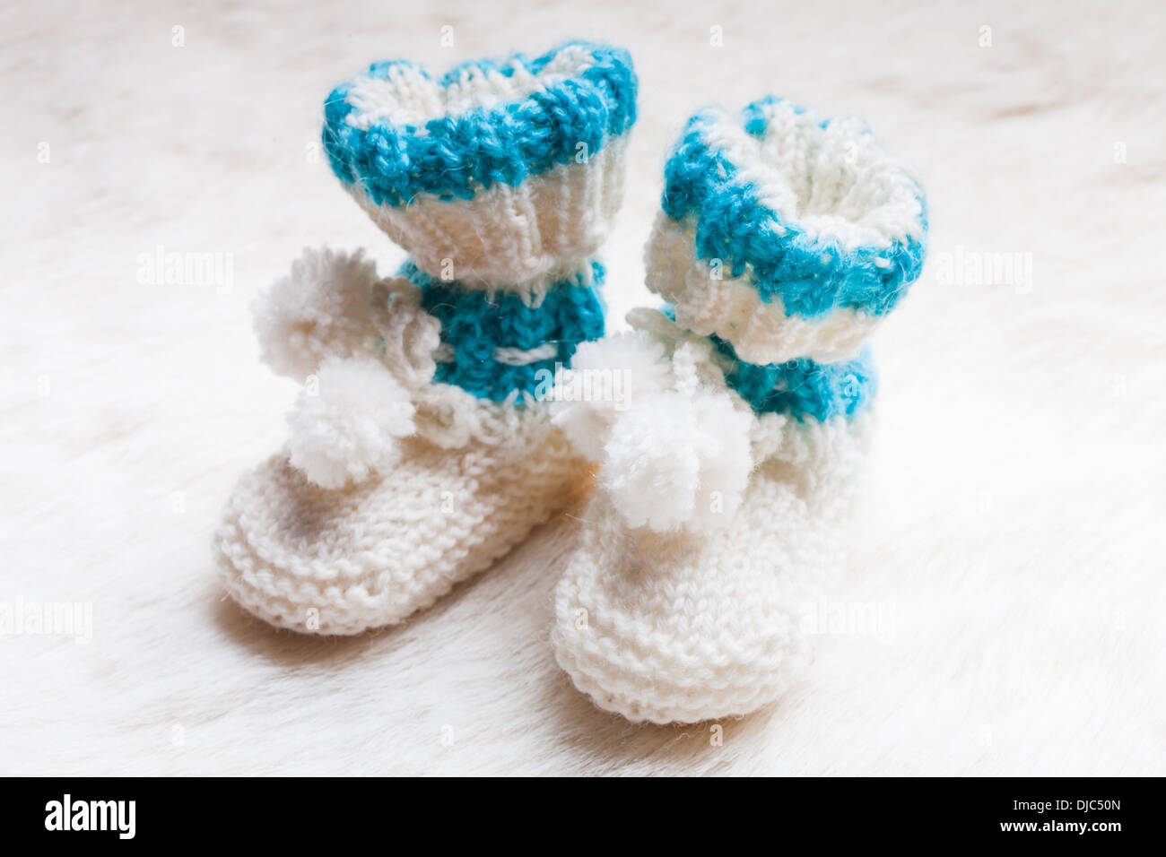 Knitted blue baby booties for little boy Stock Photo - Alamy